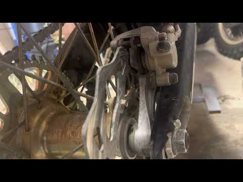 How do you replace the rear brake pads of the Beta 300RR?